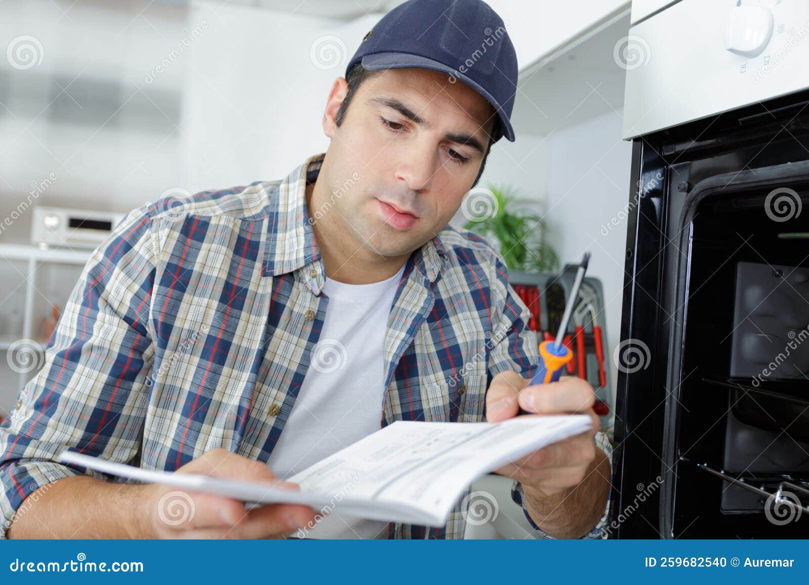 Technician with Home Appliances Reading Instructions Stock Photo ...