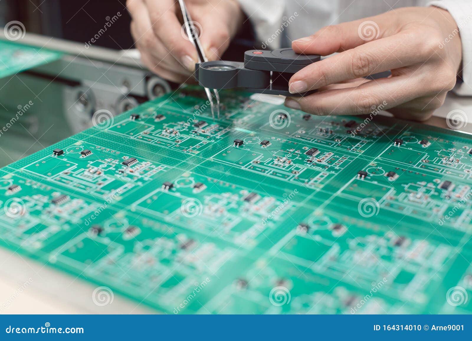 Technician Inserting Electronic Components into a PDB for Assembly ...