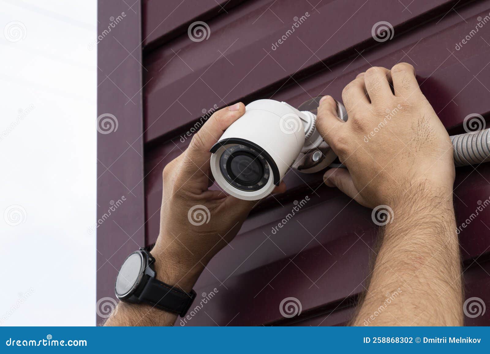 A Video Surveillance Camera in the Hands of a Technician. Installation ...