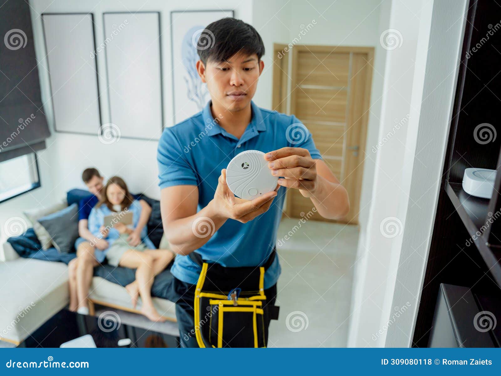 Technician Installing Fire Safety Detector in a Modern Apartment Stock ...