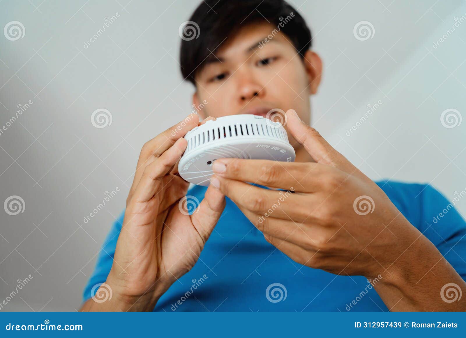 Technician Installing Fire Safety Detector in a Modern Apartment Stock ...