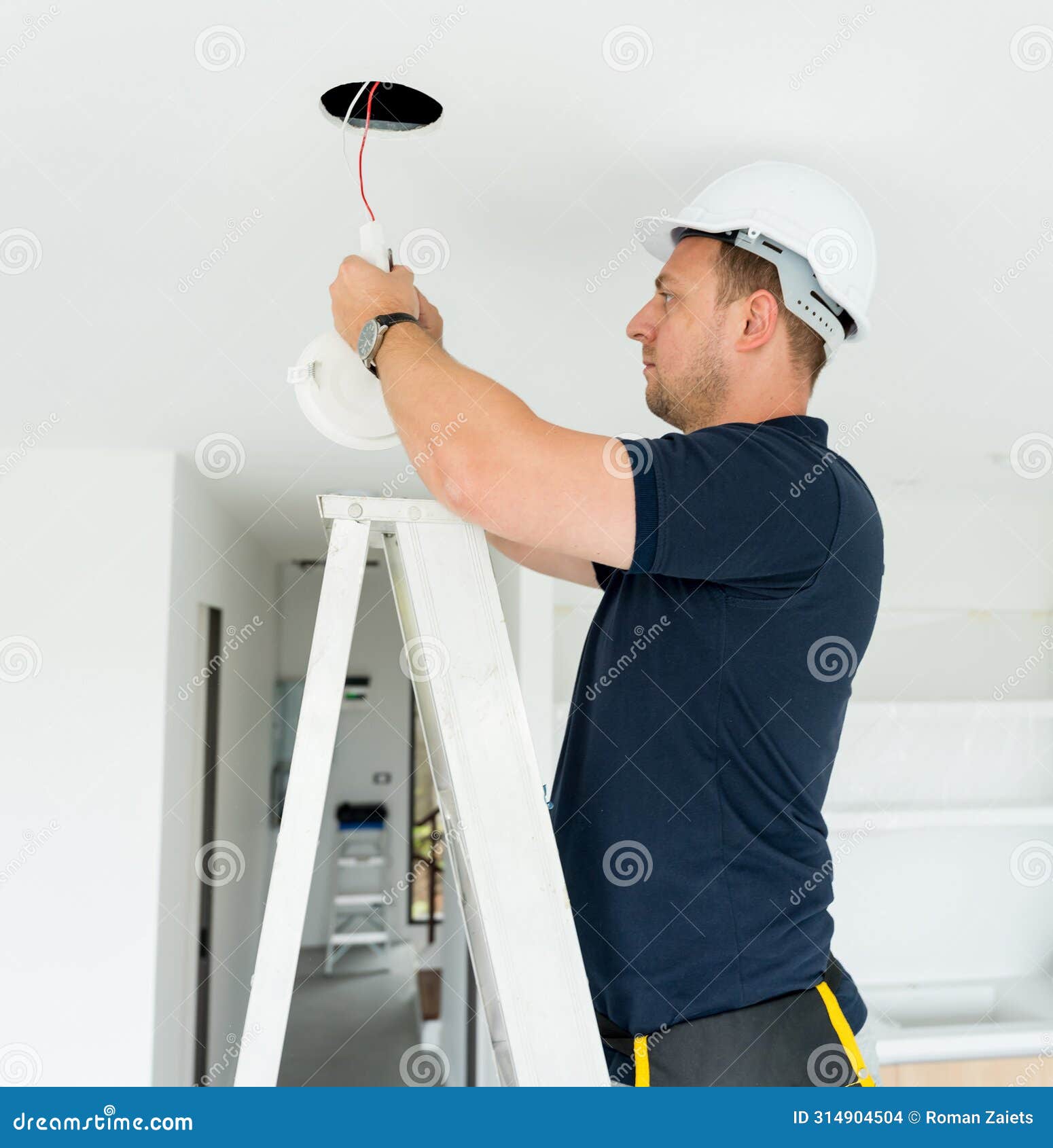 Technician is Installing an LED Spotlight in the Ceiling. Stock Photo ...