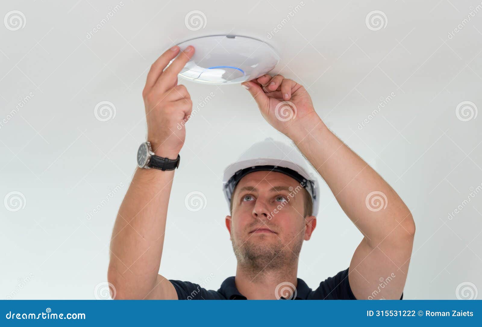 Technician is Installing an LED Spotlight in the Ceiling. Stock Photo ...