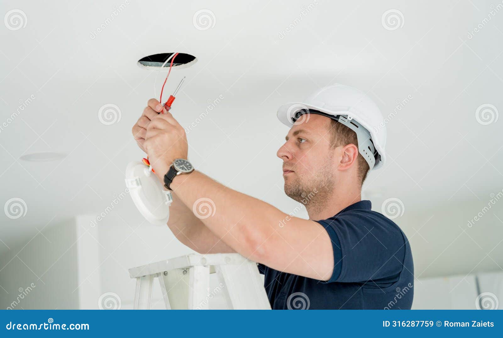 Technician is Installing an LED Spotlight in the Ceiling. Stock Image ...