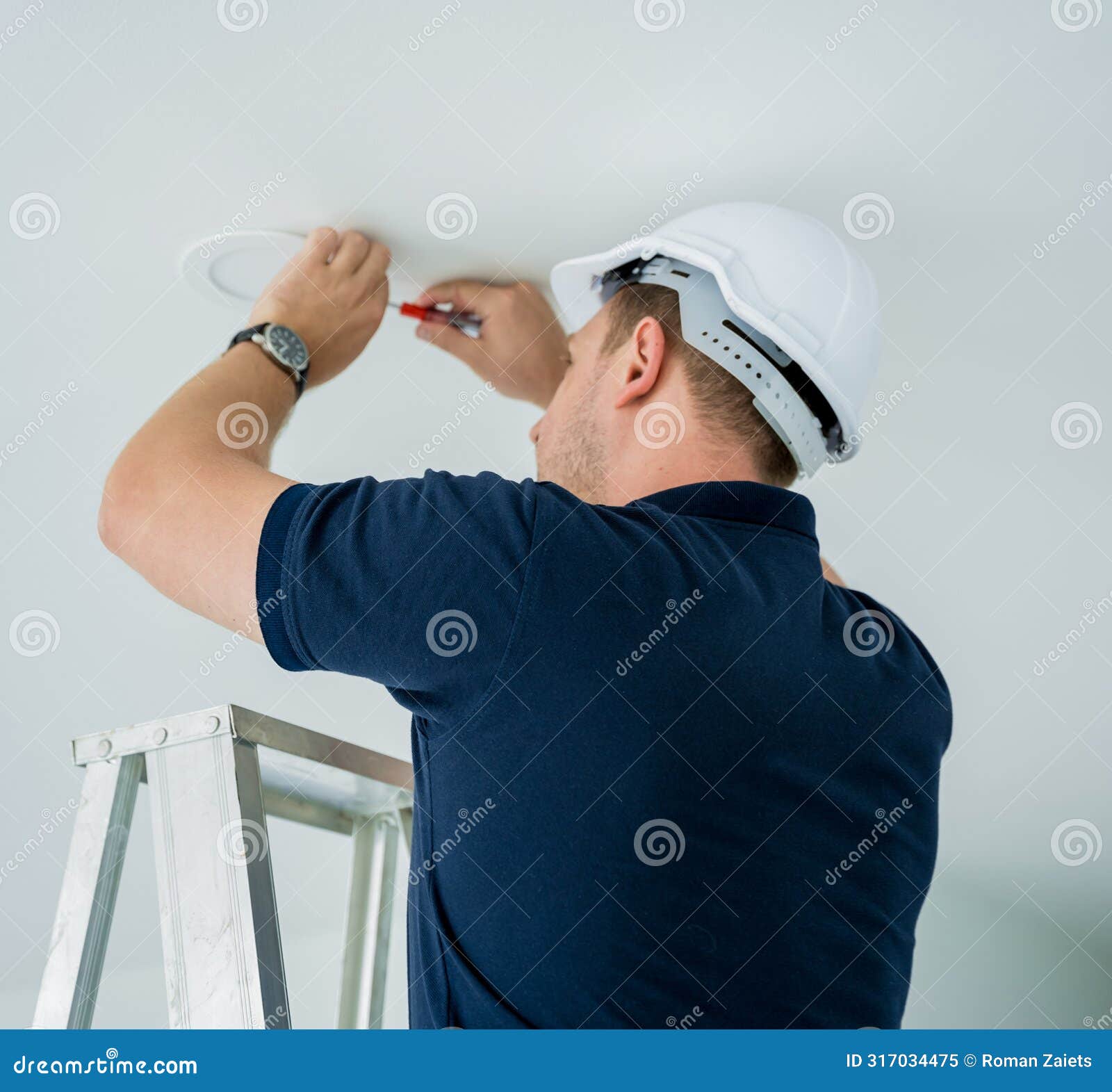 Technician is Installing an LED Spotlight in the Ceiling. Stock Image ...