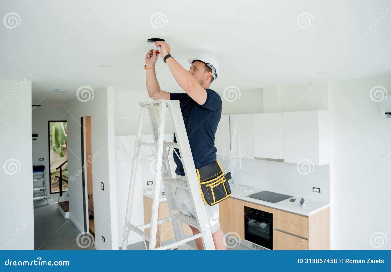 Technician is Installing an LED Spotlight in the Ceiling. Stock Photo ...