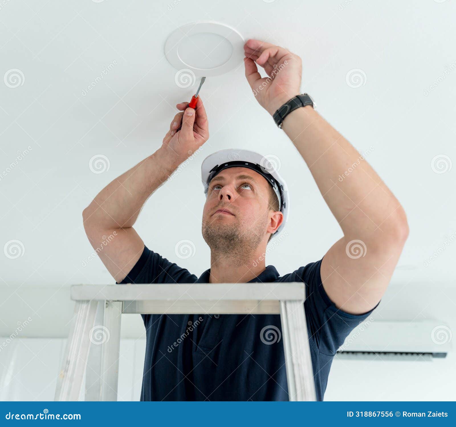 Technician is Installing an LED Spotlight in the Ceiling. Stock Photo ...