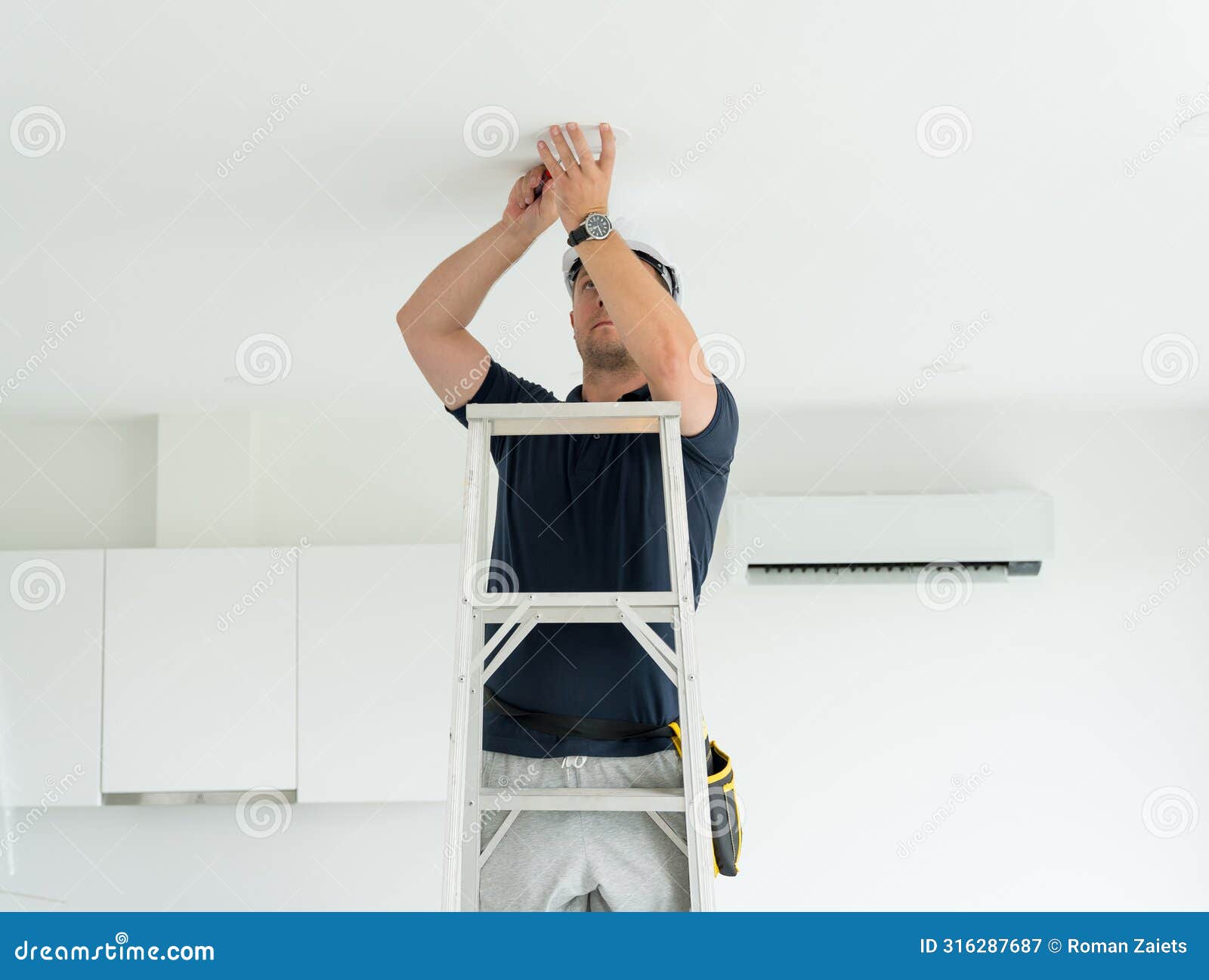 Technician is Installing an LED Spotlight in the Ceiling. Stock Image ...