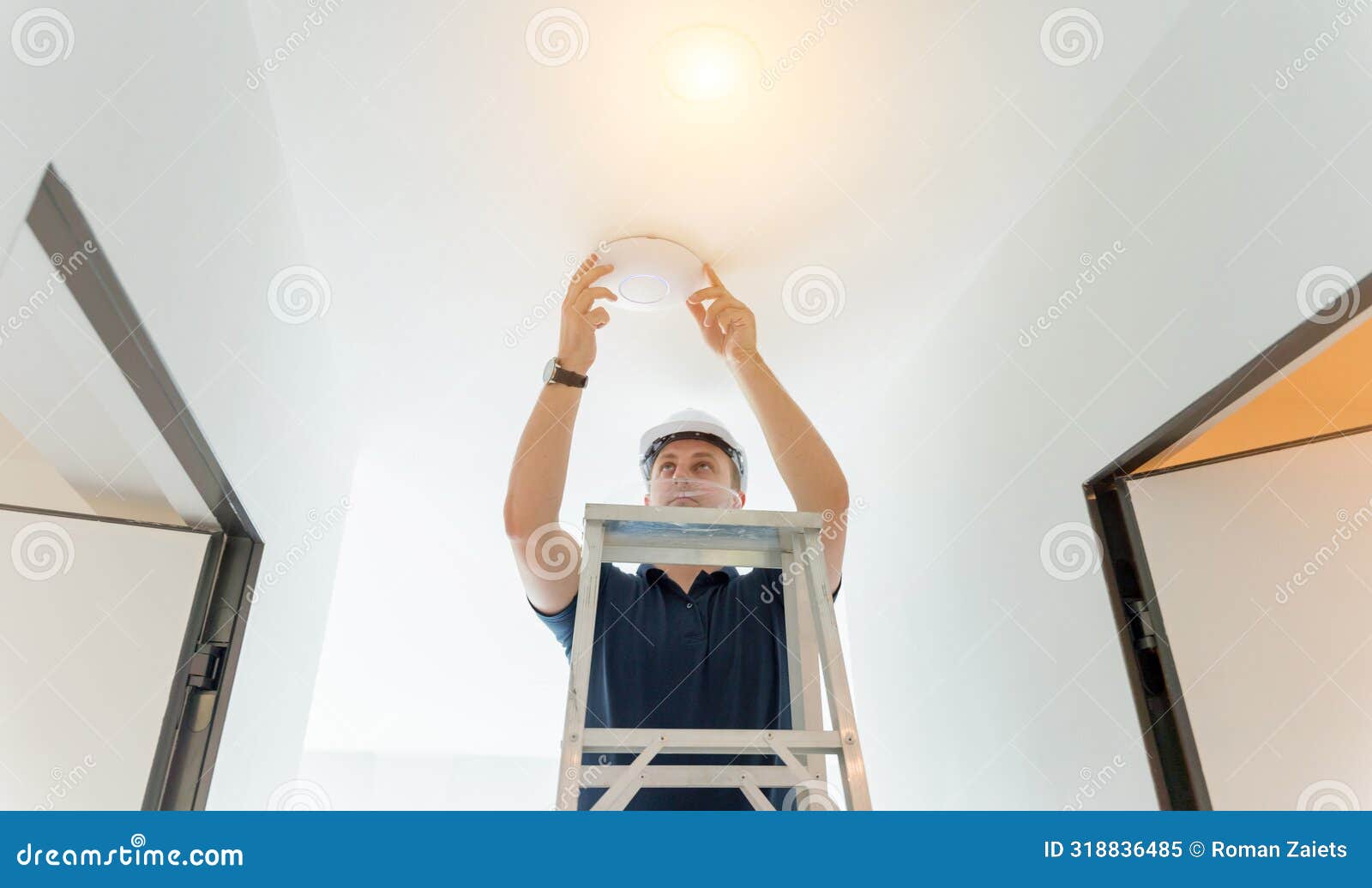 Technician is Installing an LED Spotlight in the Ceiling. Stock Image ...