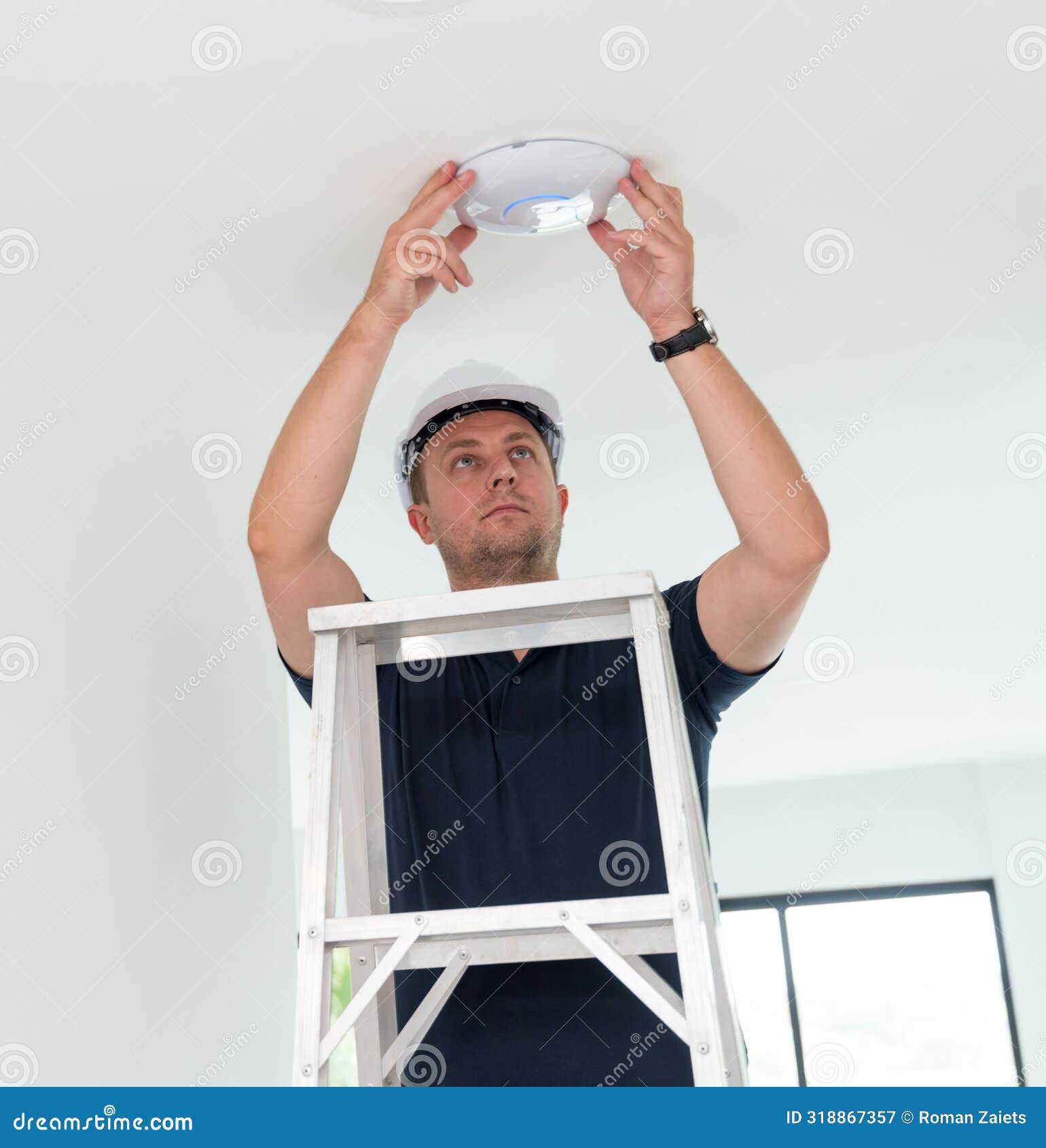 Technician is Installing an LED Spotlight in the Ceiling. Stock Image ...