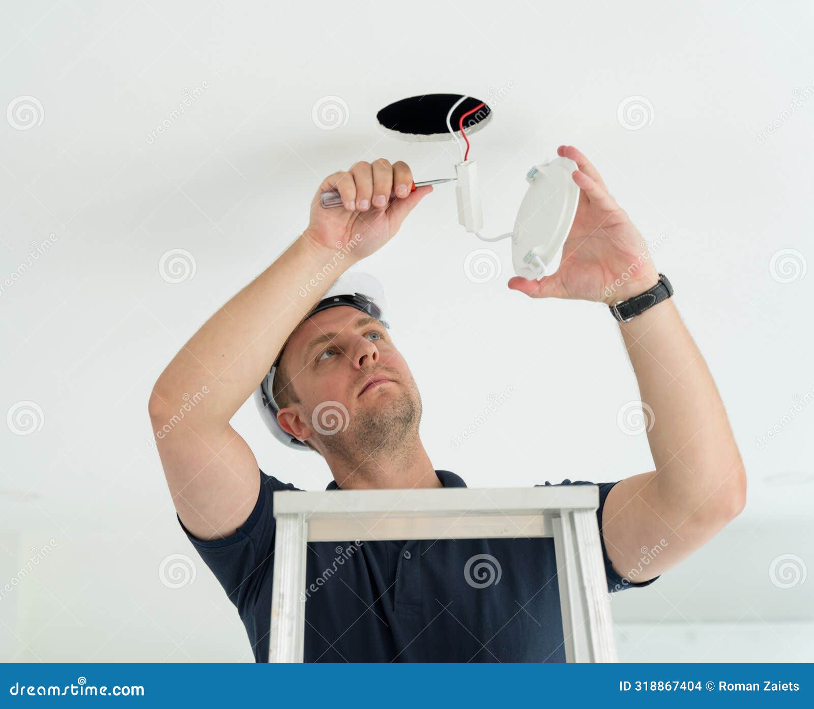 Technician is Installing an LED Spotlight in the Ceiling. Stock Photo ...