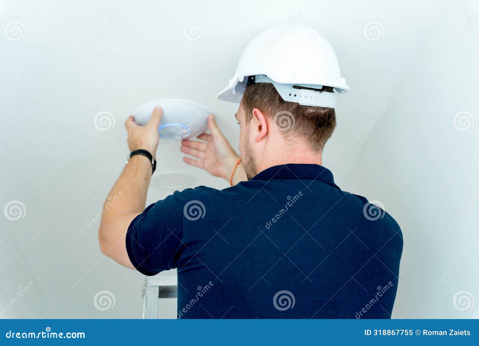 Technician is Installing an LED Spotlight in the Ceiling. Stock Image ...