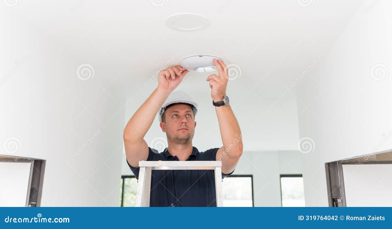 Technician is Installing an LED Spotlight in the Ceiling. Stock Photo ...