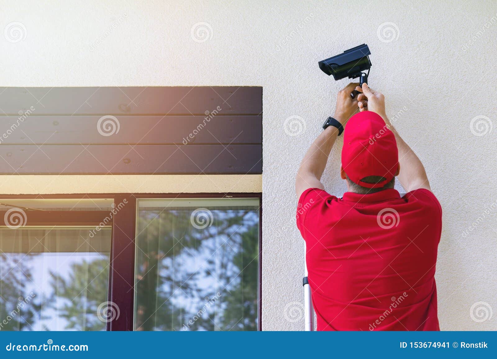 Technician Installing Outdoor Security Surveillance Camera on House ...