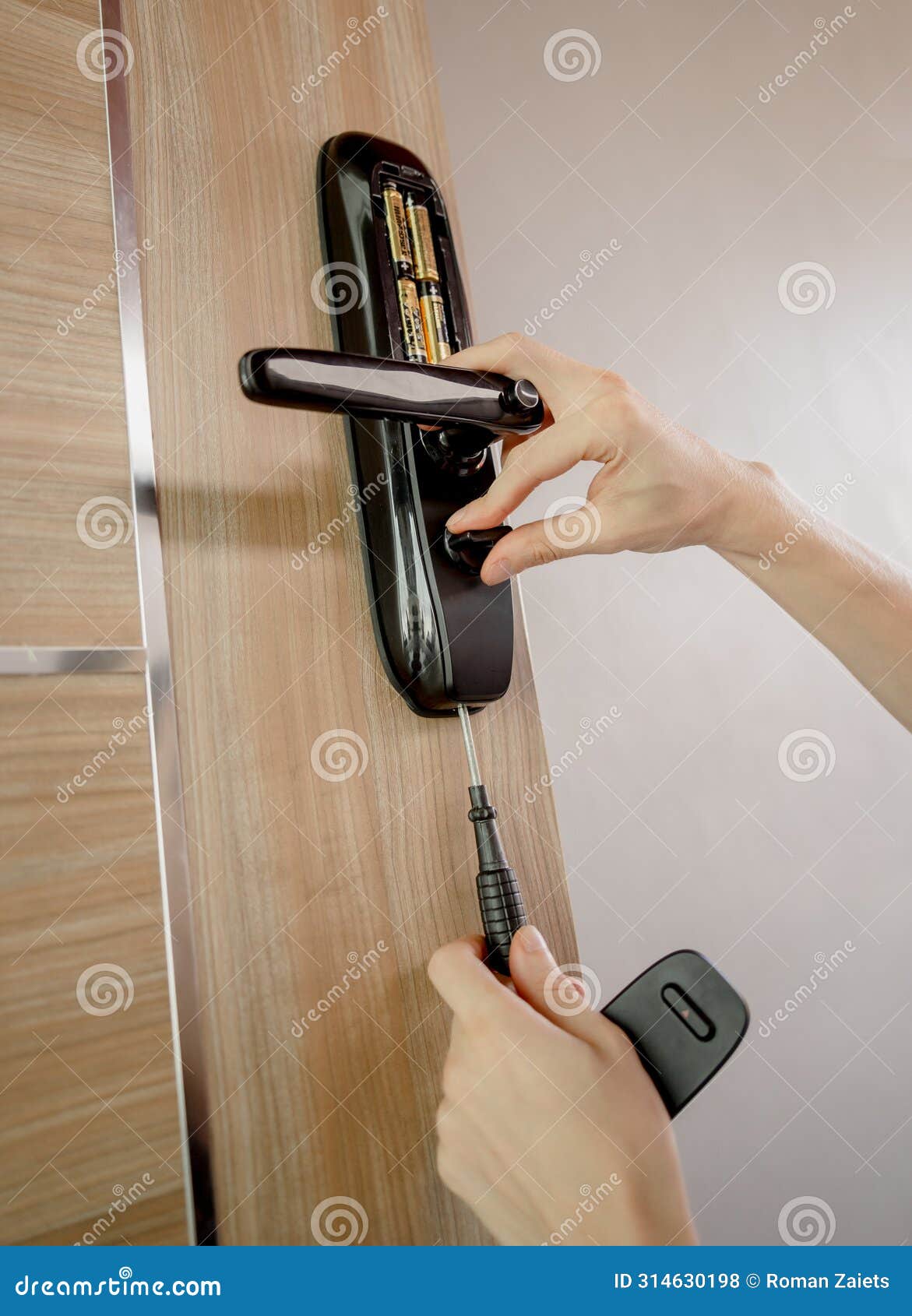 A Technician Installs a Modern Smart Door Lock on the Wood Door Stock ...