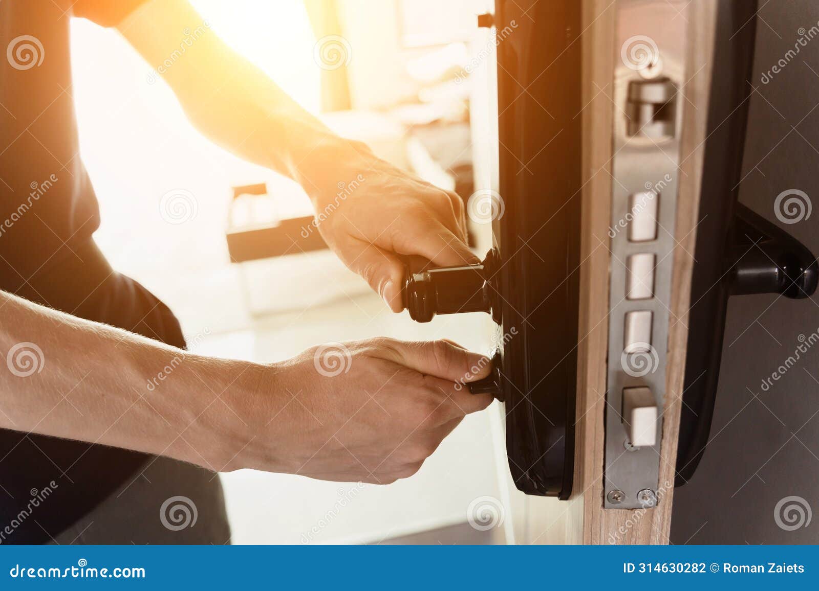 A Technician Installs a Modern Smart Door Lock on the Wood Door Stock ...