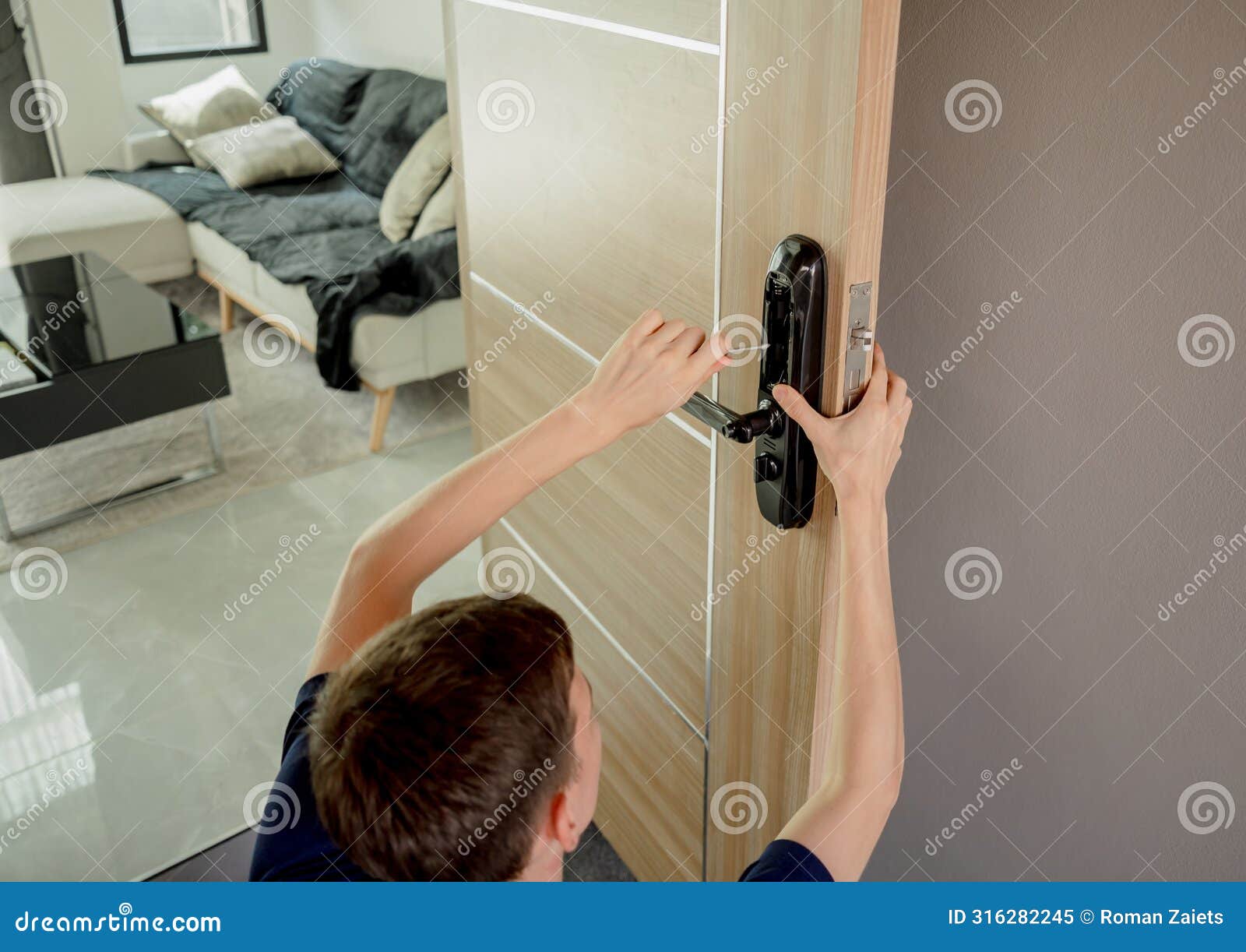 A Technician Installs a Modern Smart Door Lock on the Wood Door Stock ...