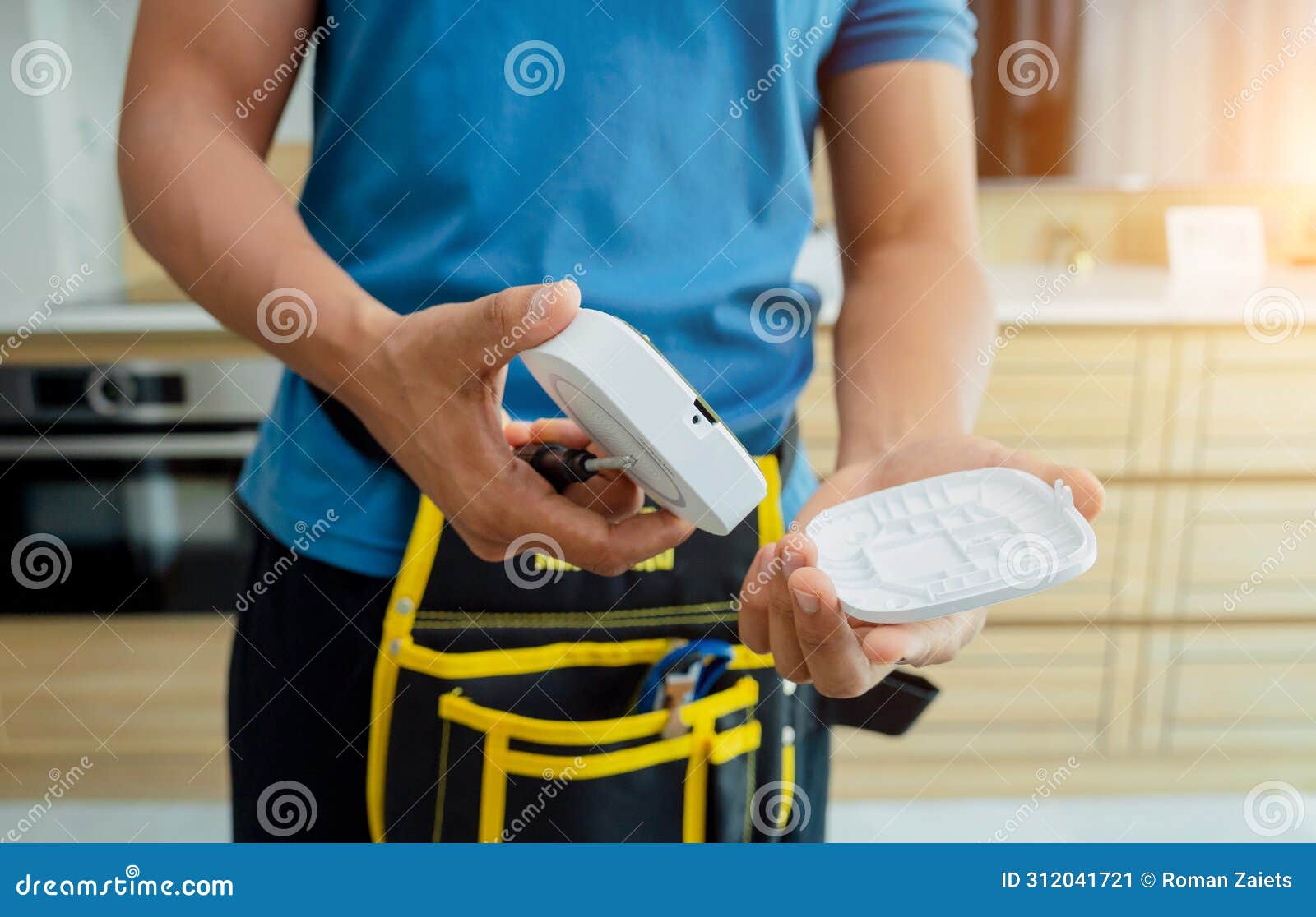 A Technician Installs a Security Alarm Siren in a Modern Apartment ...