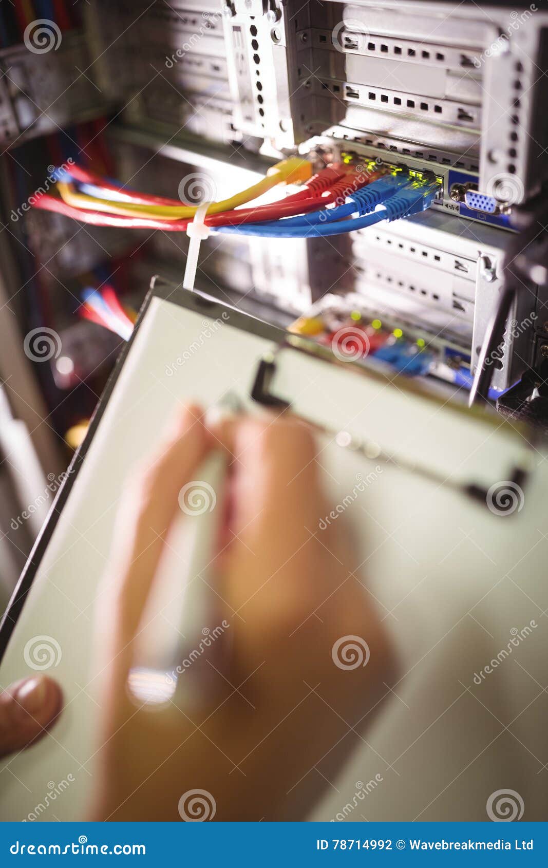 Technician Maintaining Record of Rack Mounted Server on Clipboard Stock ...