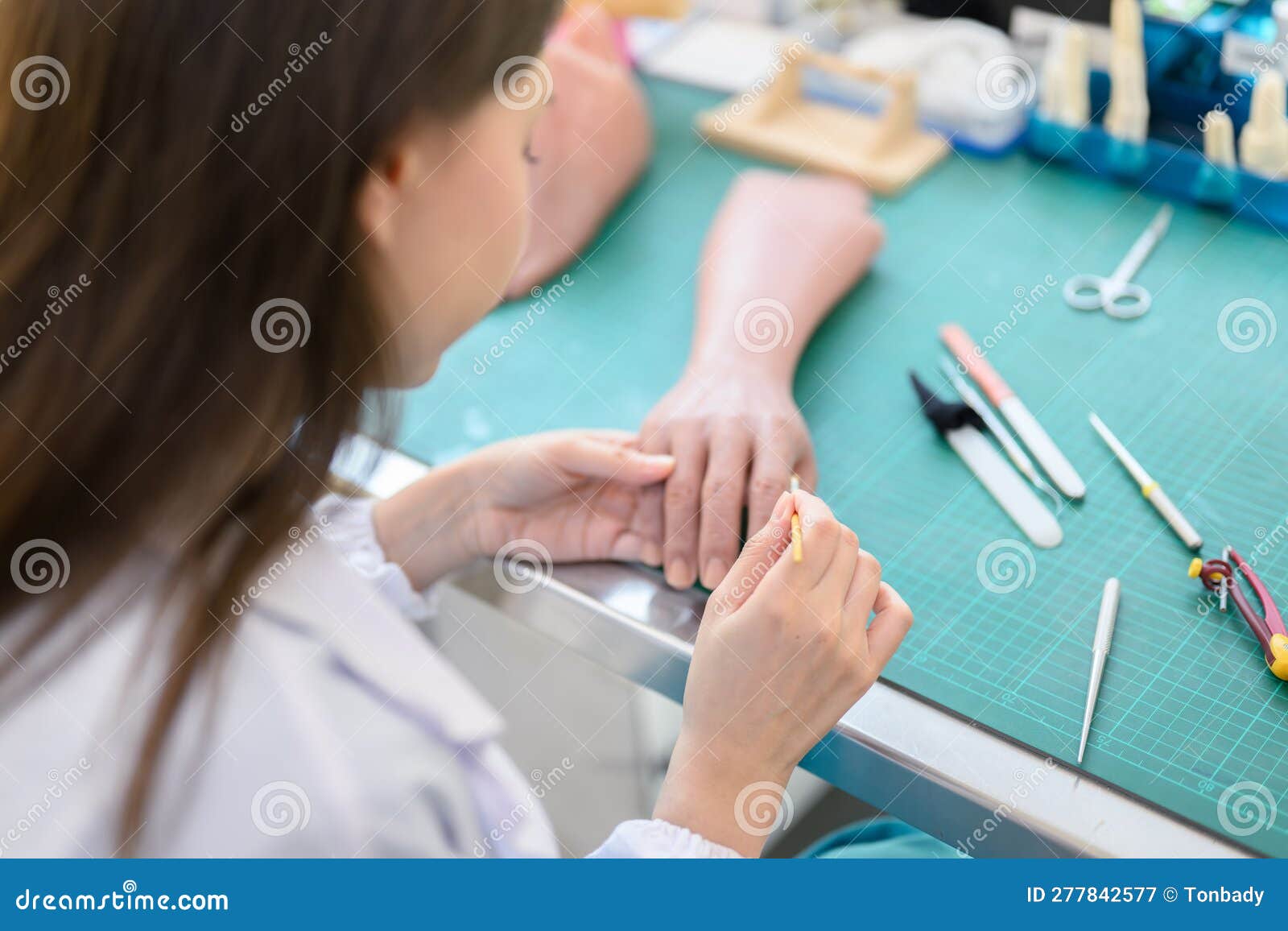 Technician Making Prosthetic Device Using Grinder To Smooth Socket ...