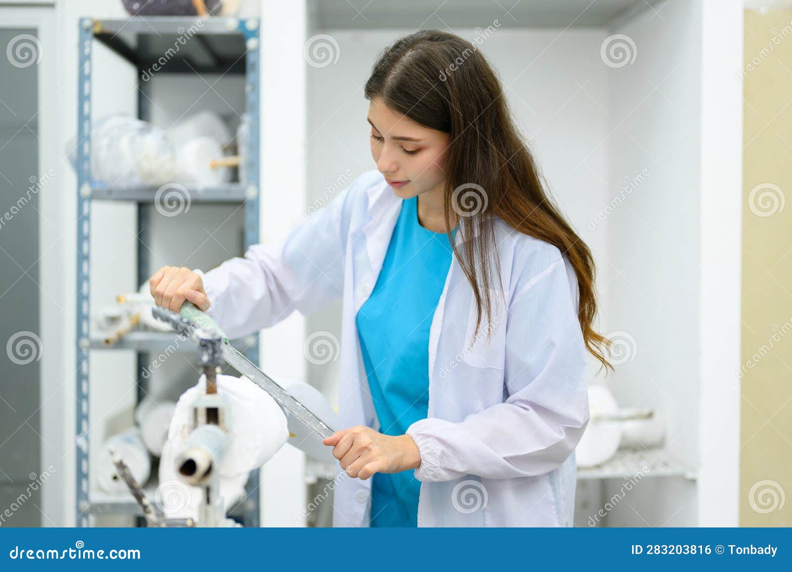 Technician Making Prosthetic Device Using Grinder To Smooth Socket ...