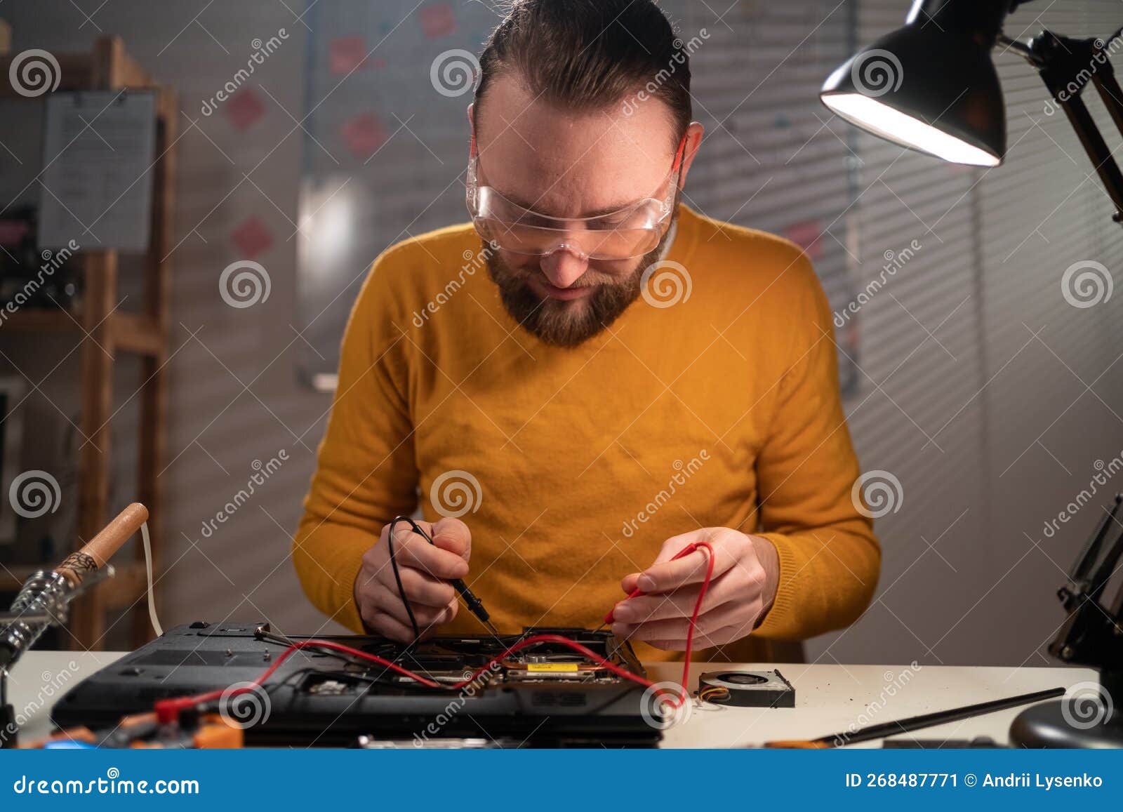 Technician Man Measuring Electrical Voltage of Laptop Computer ...