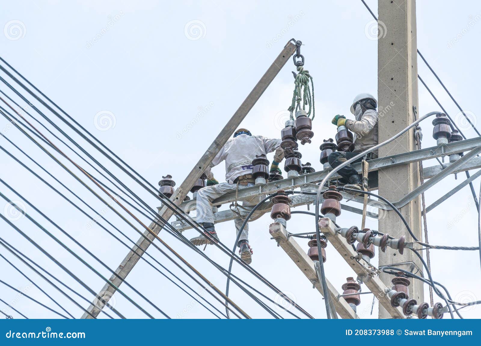 Technician Men Fixing or Repairing Broken Power Line on Electric Pole ...