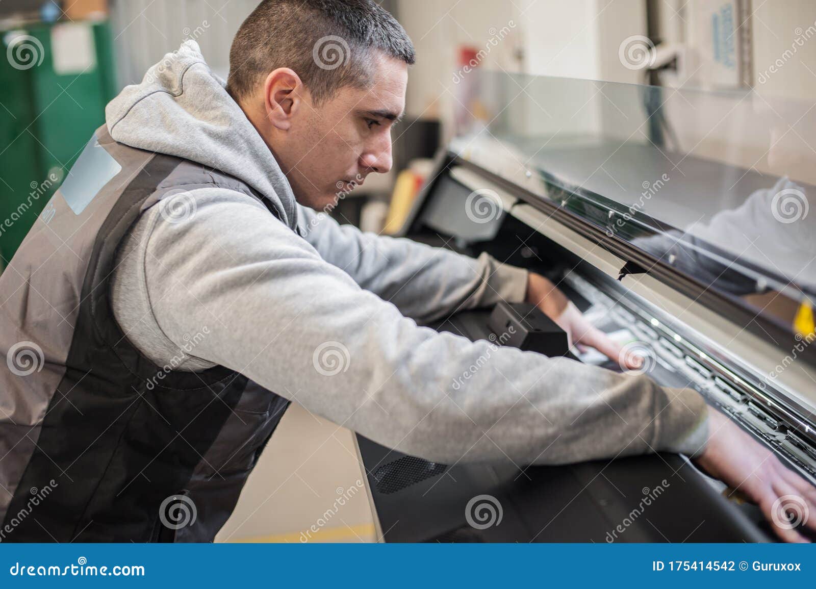 Technician Operator Changes Paper Roll on Large Printer Plotter Machine ... Technician Operator Changes Paper Roll on Large Printer Plotter Machine ...