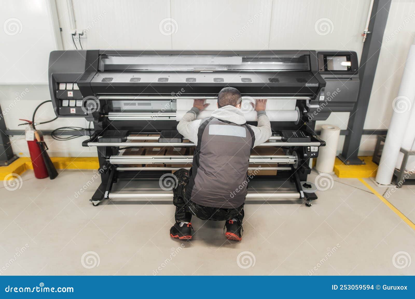 Technician Operator Changes Paper Roll on Large Printer Plotter Machine ... Technician Operator Changes Paper Roll on Large Printer Plotter Machine ...