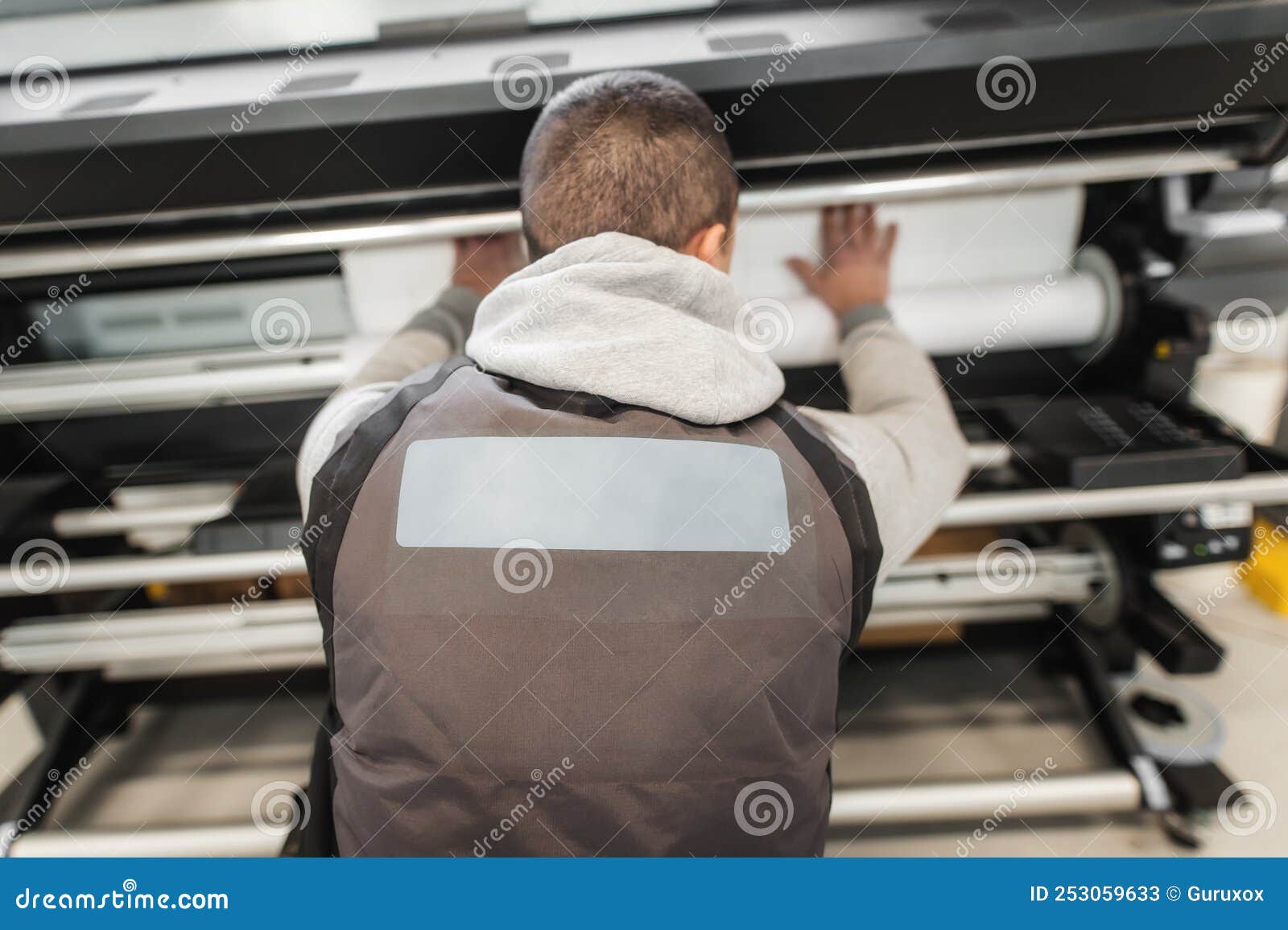 Technician Operator Changes Paper Roll on Large Printer Plotter Machine ...