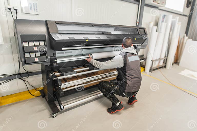 Technician Operator Changes Paper Roll on Large Printer Plotter Machine ...