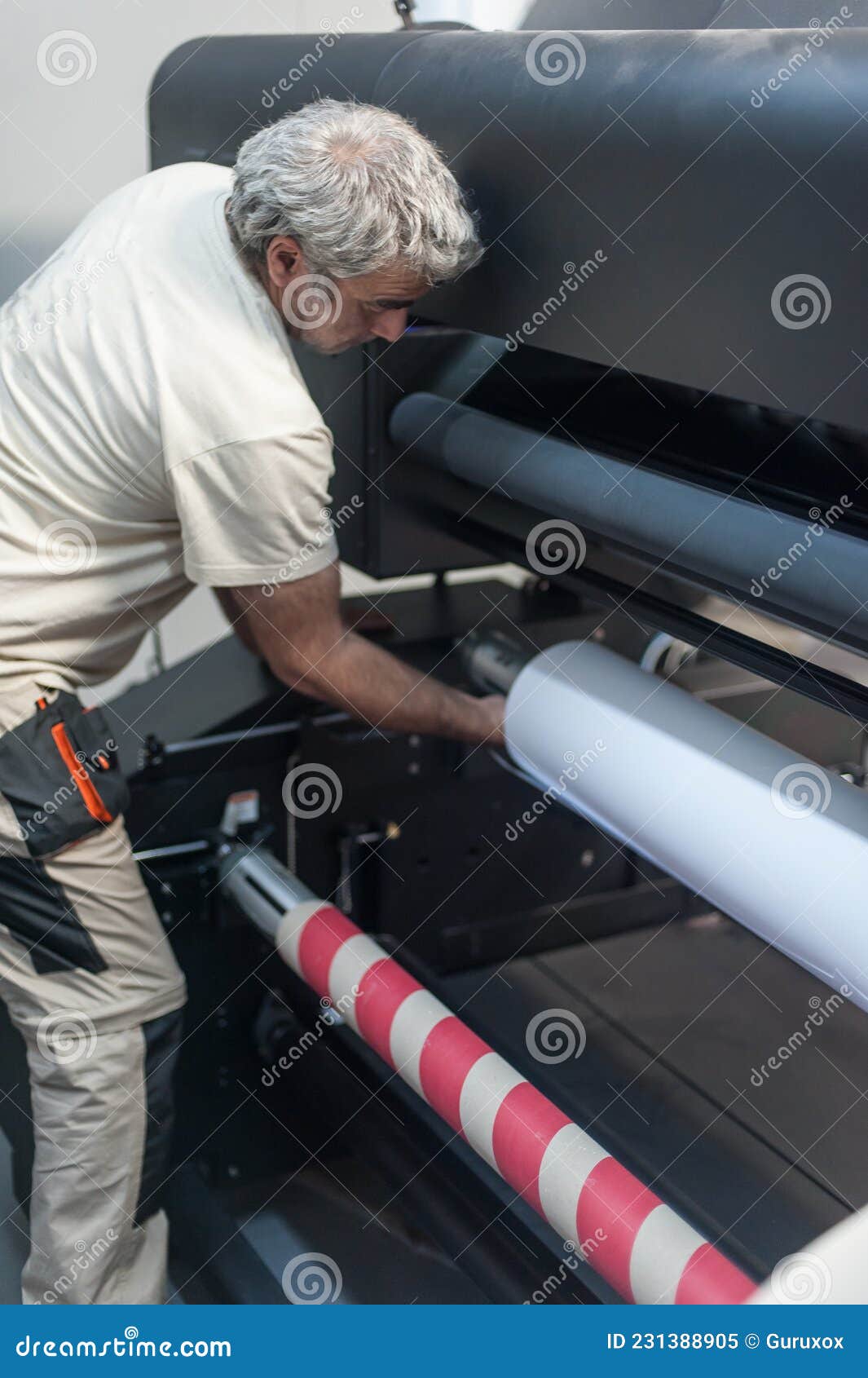 Technician Operator Changes Paper Roll on Large Printer Plotter Machine ...