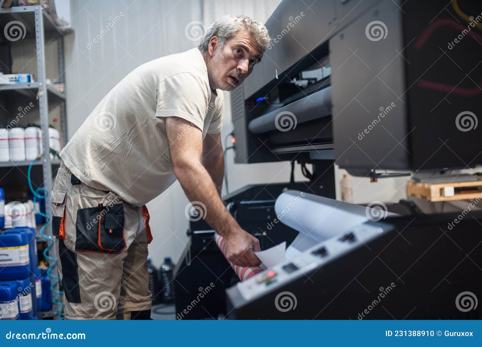 Technician Operator Changes Paper Roll on Large Printer Plotter Machine ...