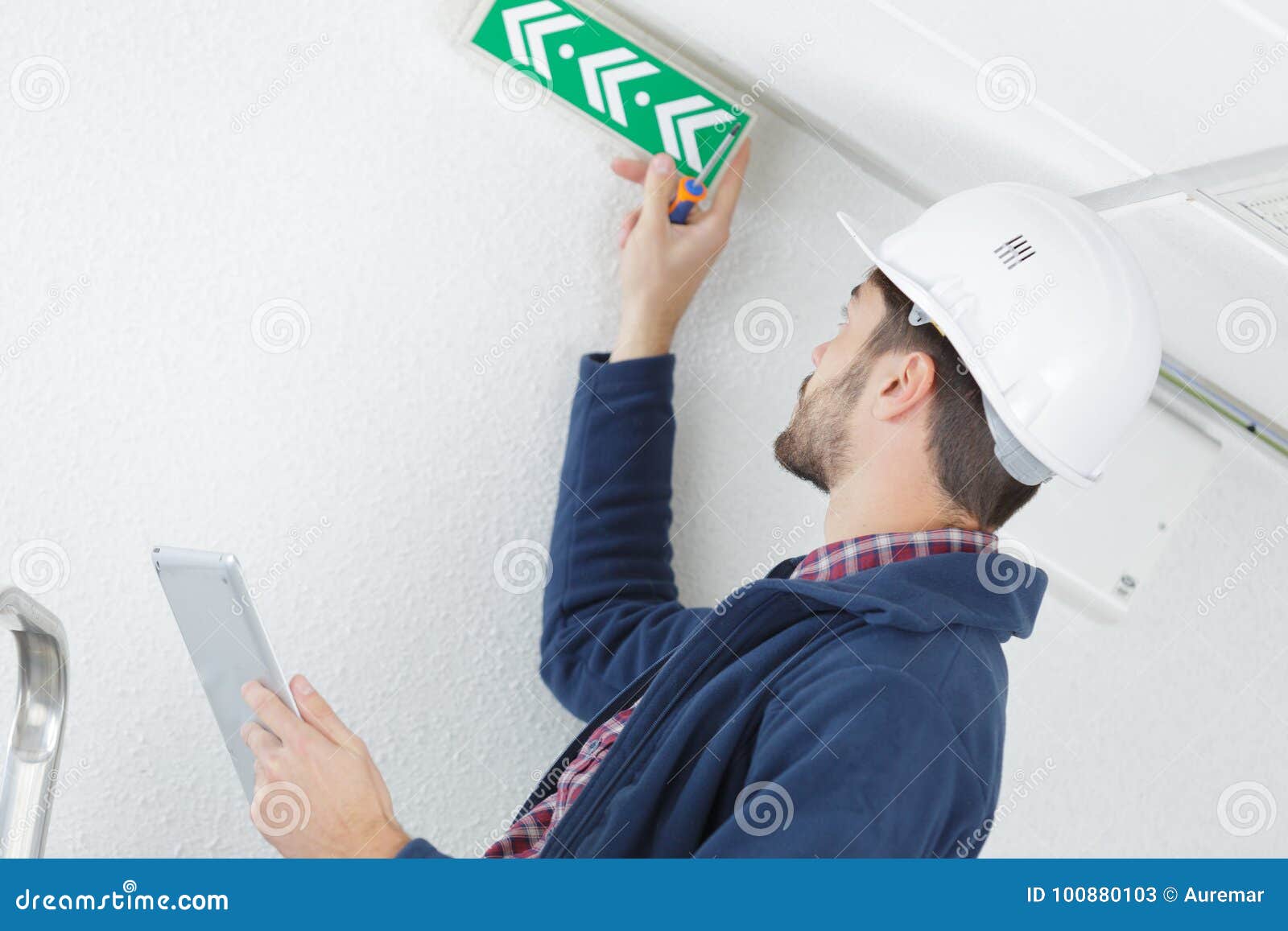 Technician Placing Emergency Exit Sign Stock Image - Image of door ...