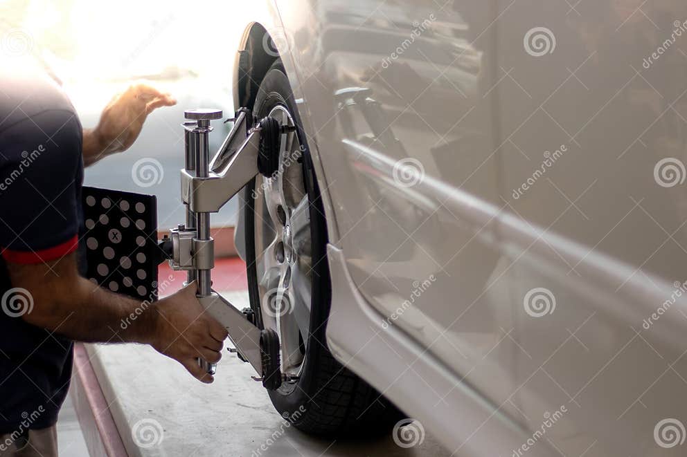Technician Placing Sensor during Wheel Alignment. 3d Wheel Alignment ...