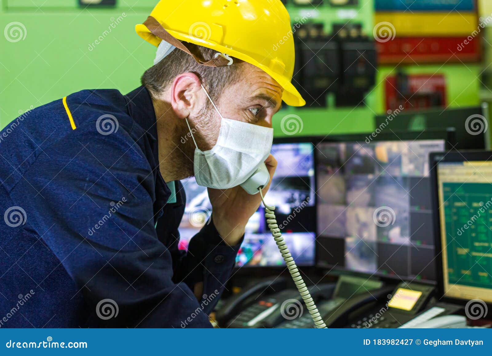 Technician with Protective Mask Working on Computer and Doing Telephone ...