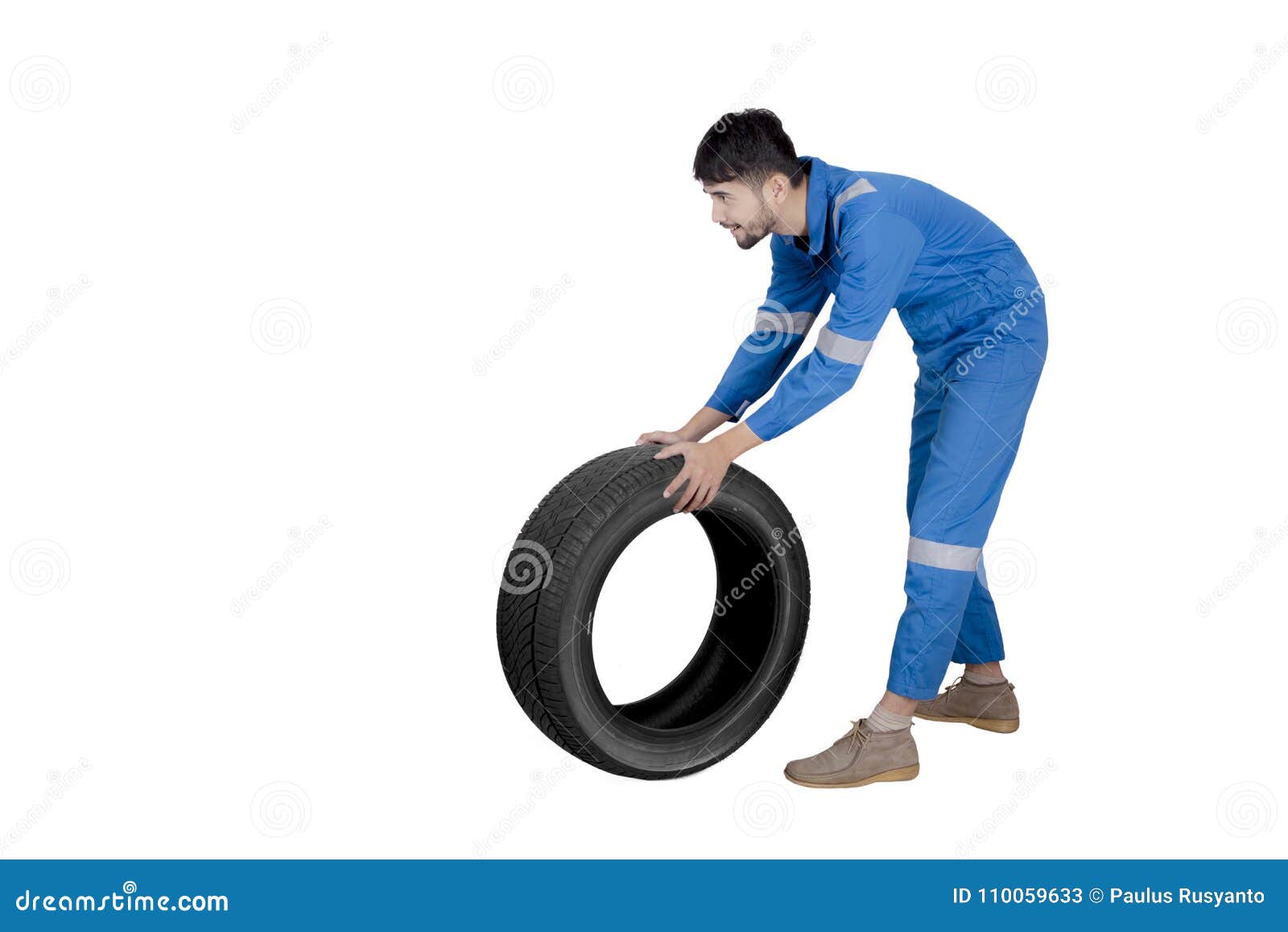 Technician pushing a tyre stock image. Image of heavy - 110059633