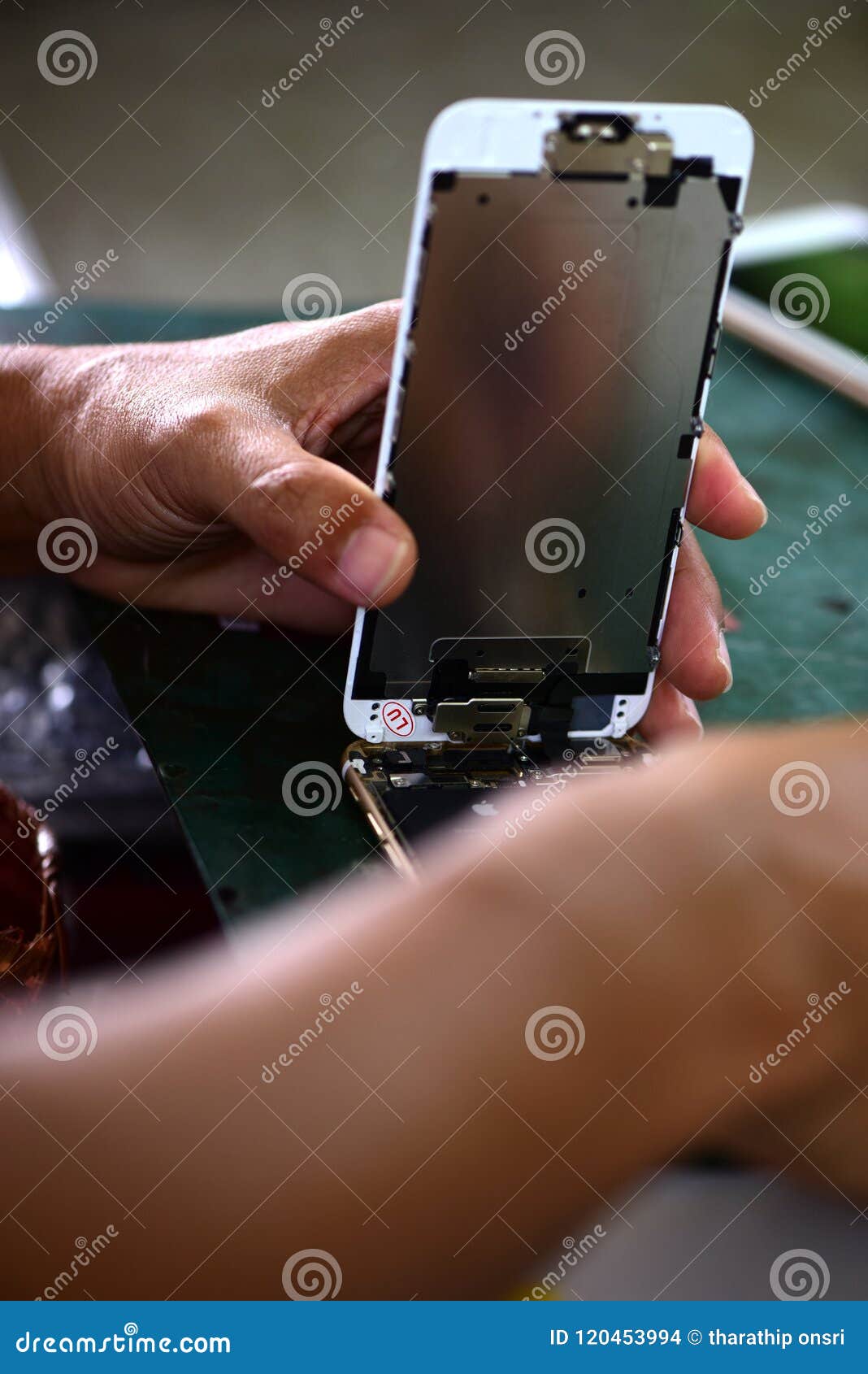 Repairing Mobile Phones and Tablets by Skilled Technicians. Stock Photo ...