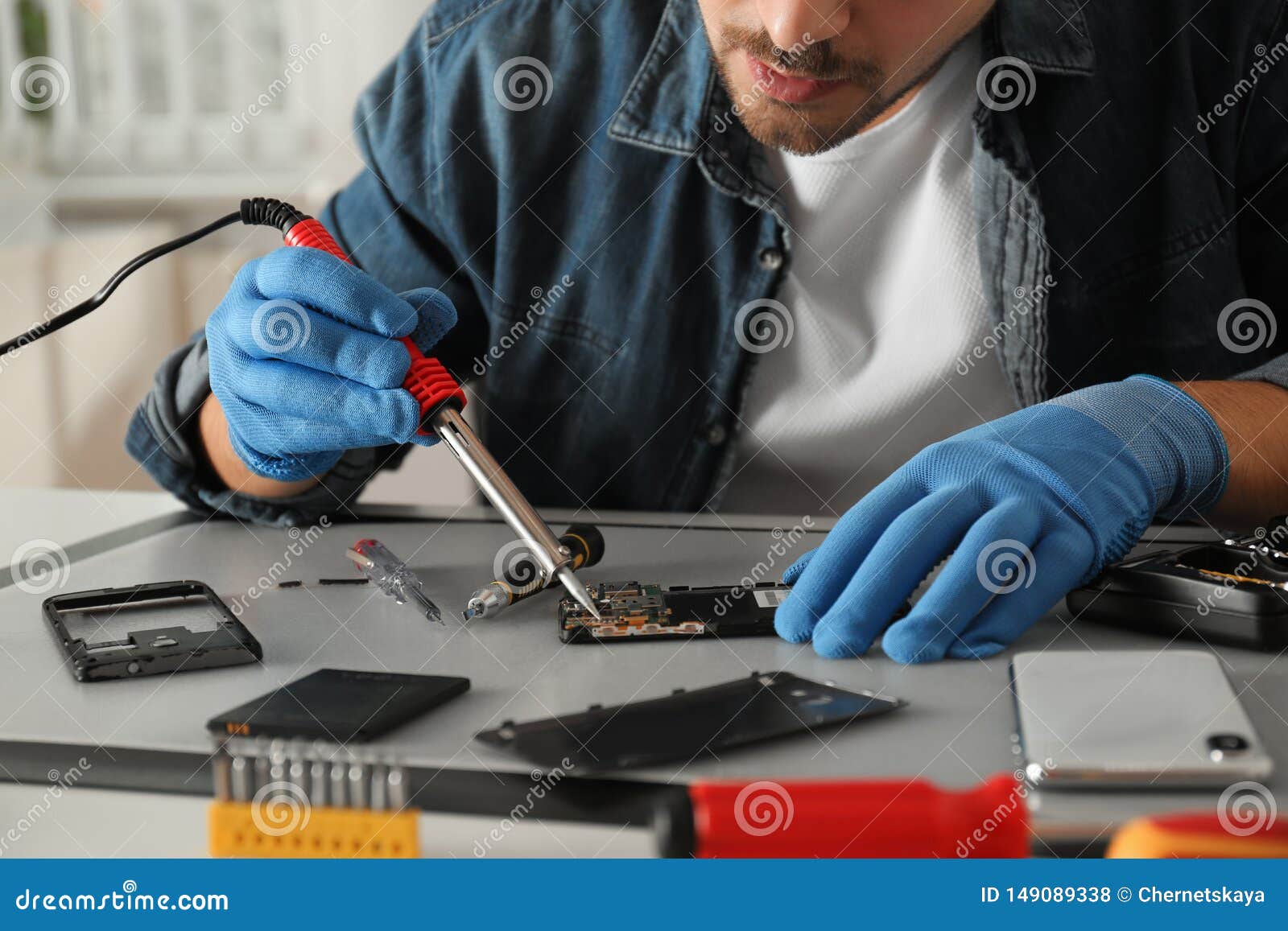 Technician Repairing Broken Smartphone at Table Stock Photo - Image of ...