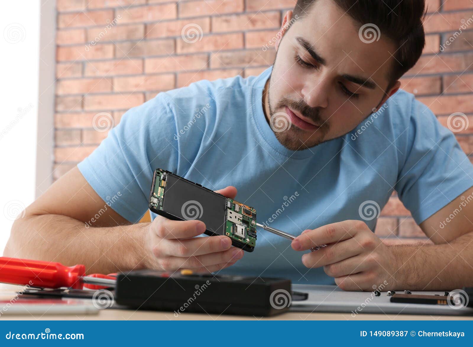 Technician Repairing Broken Smartphone in Workshop Stock Image - Image ...