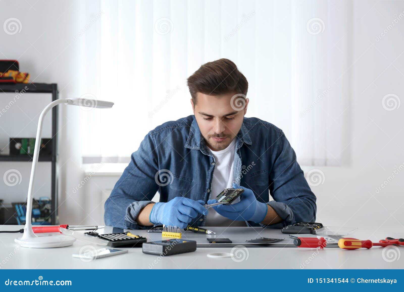 Technician Repairing Broken Smartphone at Table Stock Photo - Image of ...