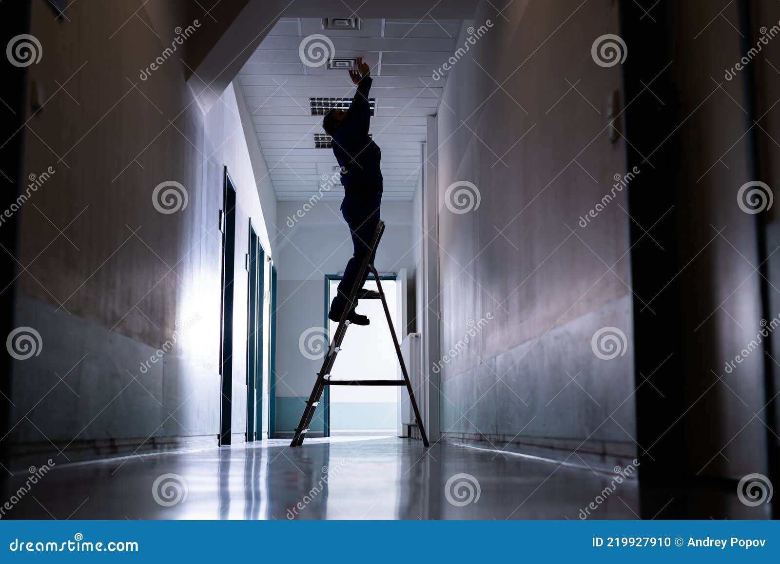 Technician Repairing Ceiling Fixture in Office Stock Photo - Image of ...