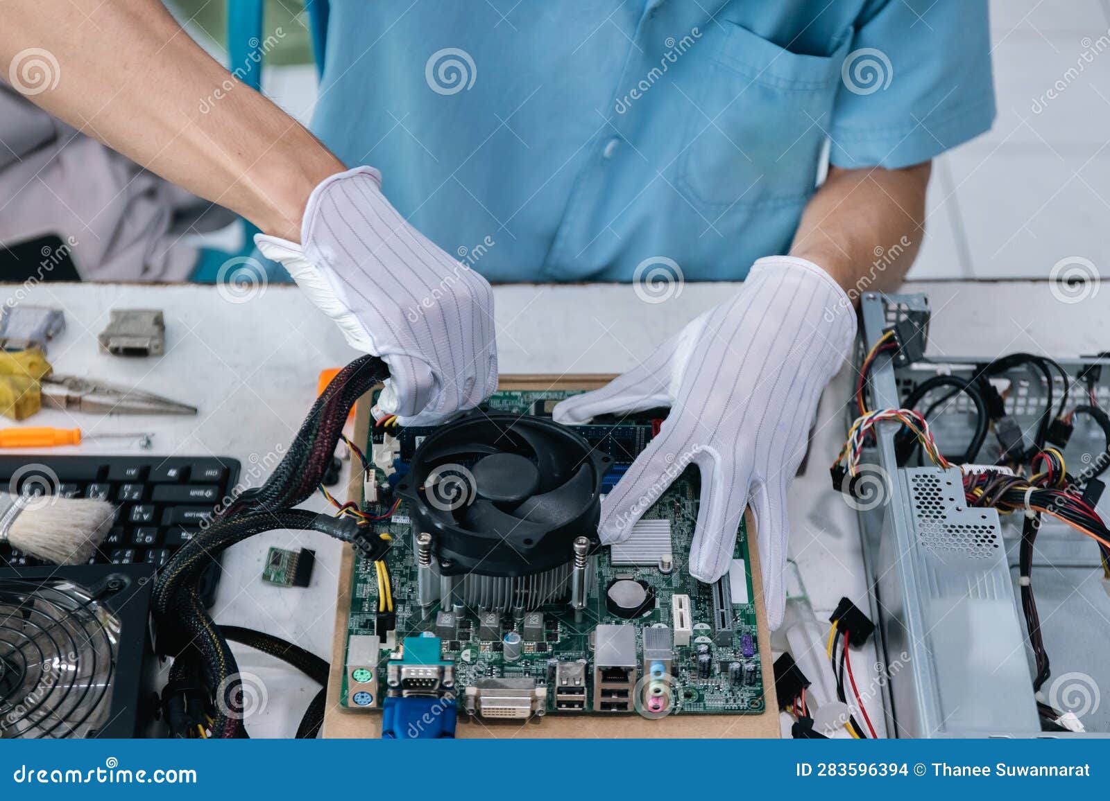 A Technician is Repairing a Computer by Cleaning the Cooling Fan ...