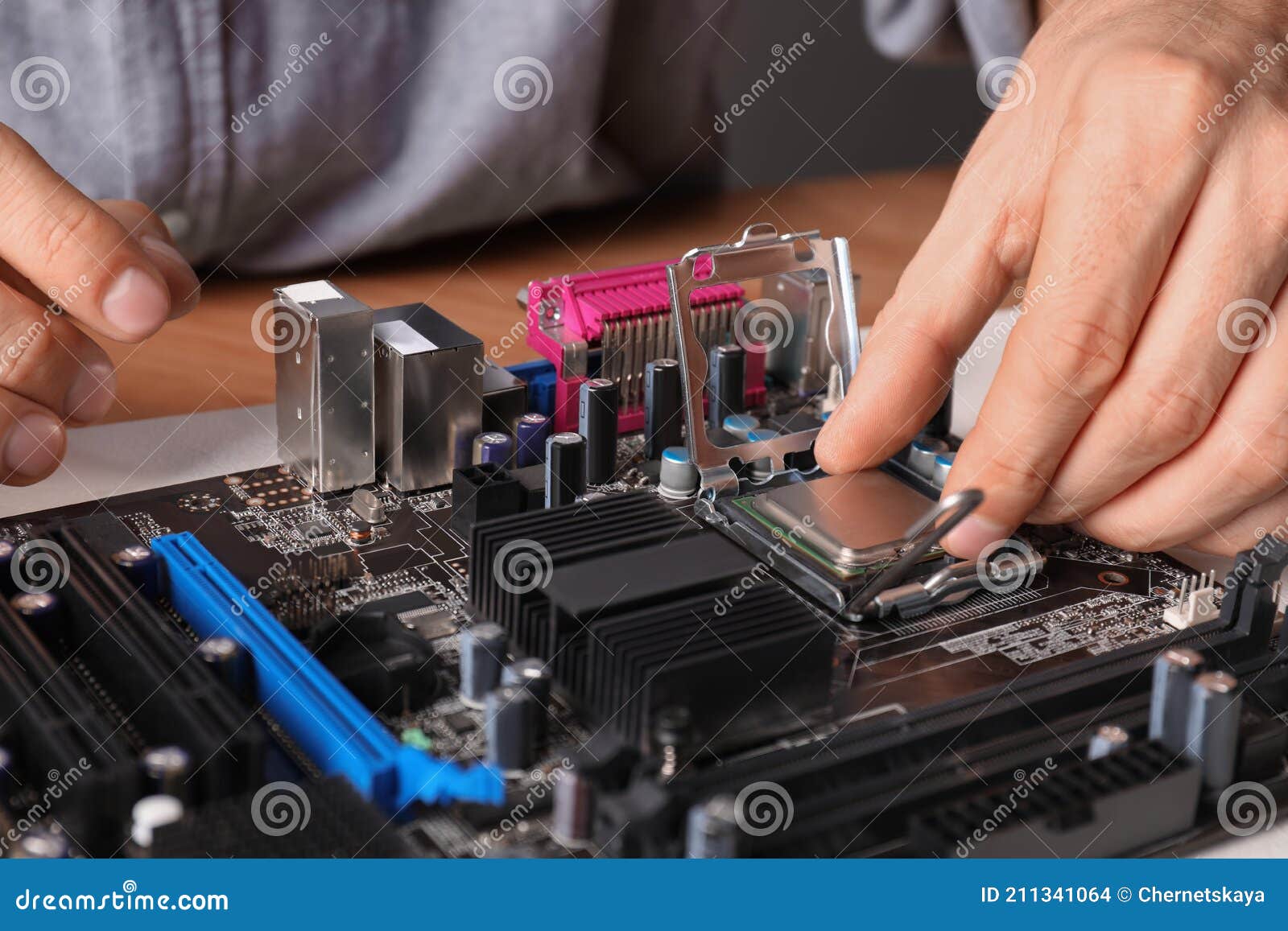 Technician Repairing Computer Motherboard at Table, Closeup. Electronic ...