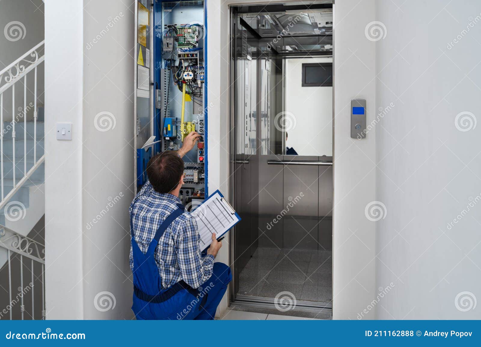 Technician Repairing Elevator Stock Photo - Image of checking ...