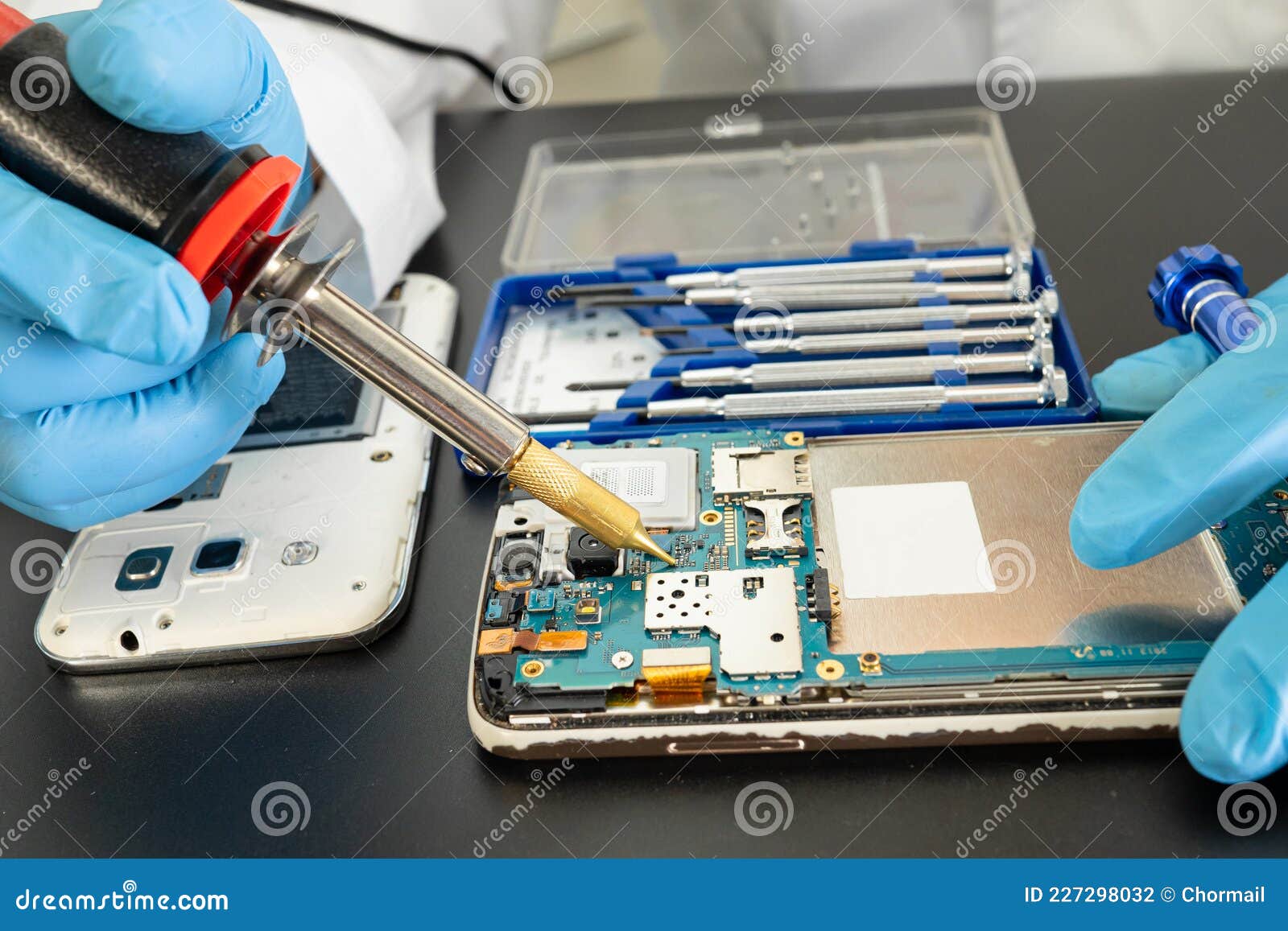 Technician Repairing Inside of Mobile Phone by Soldering Iron ...