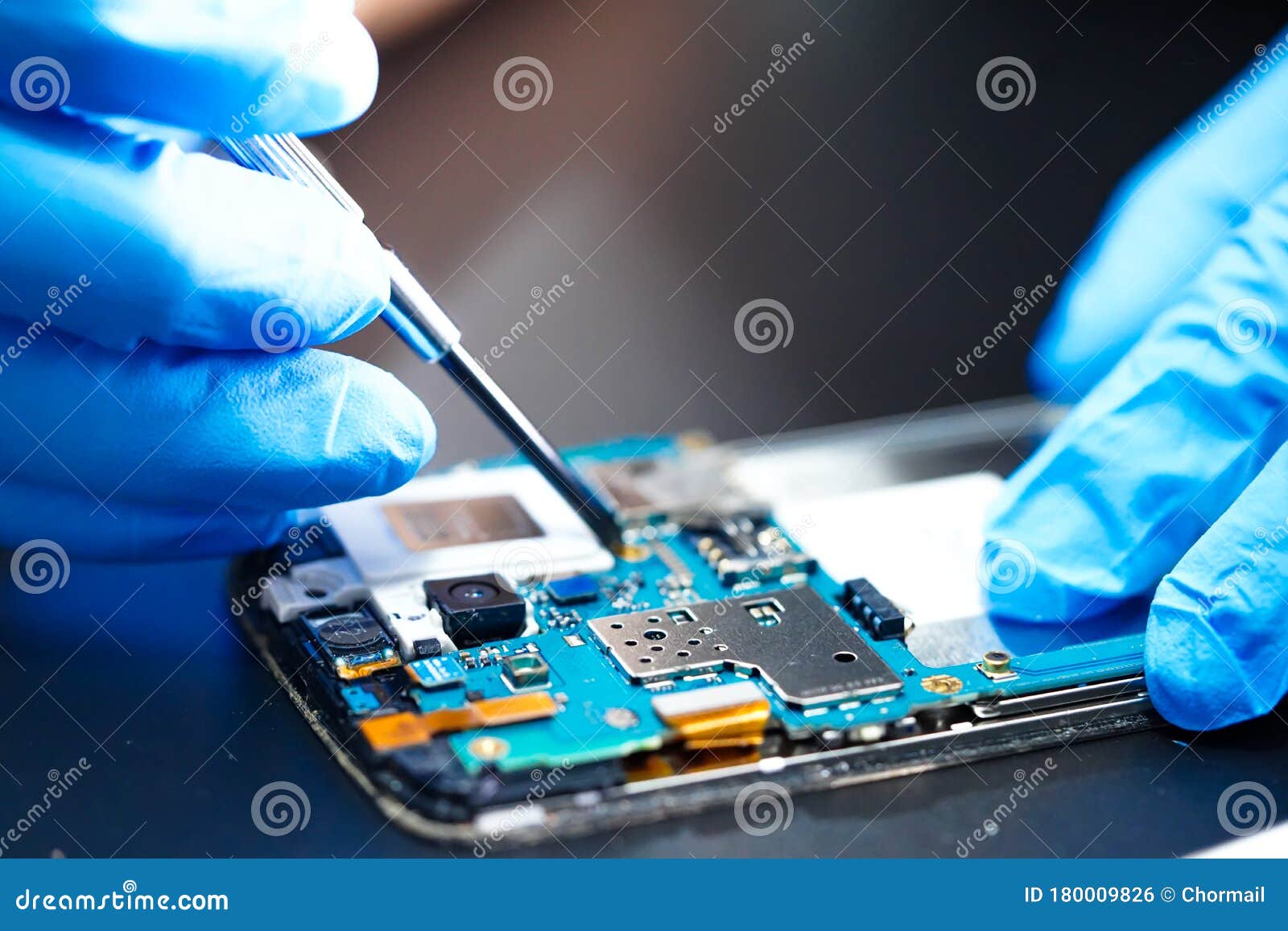 Technician Repairing Micro Circuit Main Board of Smartphone Electronic ...