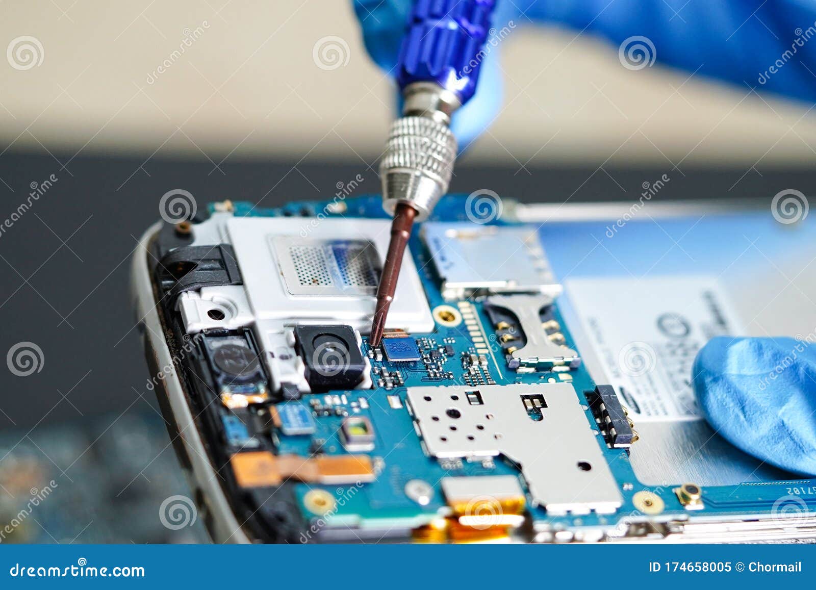 Technician Repairing Micro Circuit Main Board of Smartphone Electronic ...