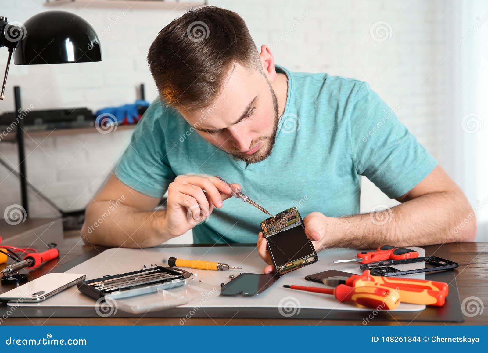 Technician Repairing Mobile Phone at Table Stock Photo - Image of ...