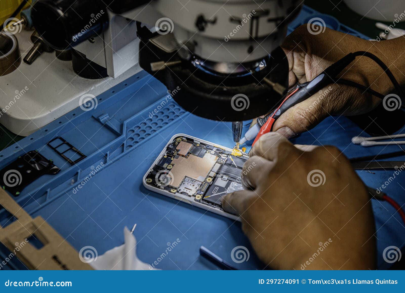 A Technician Repairing a Mobile Phone Under a Magnifying Microscope on ...